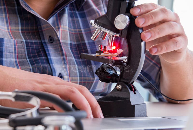 High Precision Engineering with Man Working with Microscope Stock Image ...