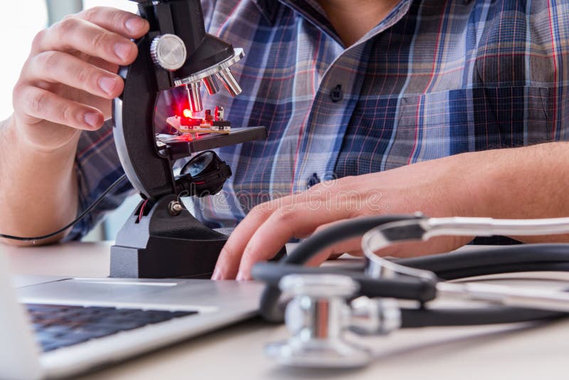 The High Precision Engineering with Man Working with Microscope Stock ...