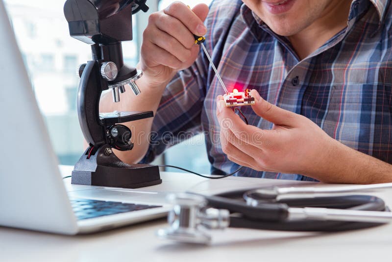 The High Precision Engineering with Man Working with Microscope Stock ...