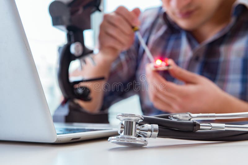 The High Precision Engineering with Man Working with Microscope Stock ...