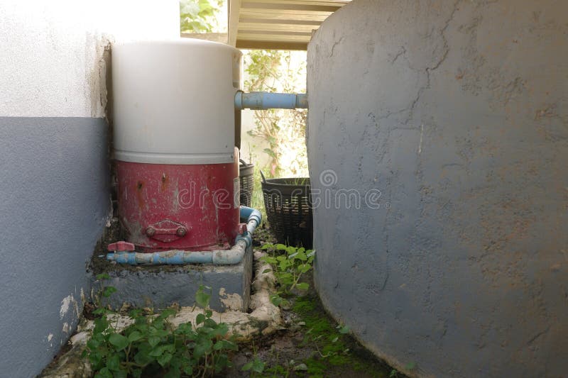 High Pressure Automatic Water Pump Installed between the House Wall and ...