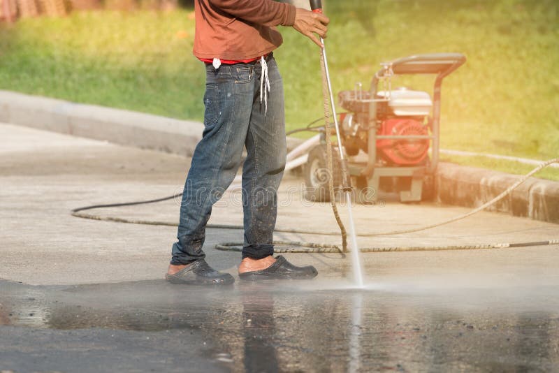 Worker Cleaning Driveway at Construction Area. Stock Photo - Image of ...