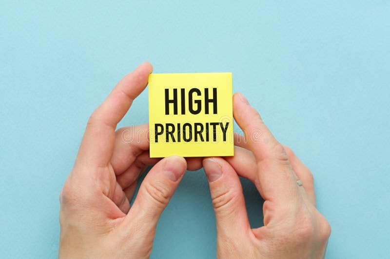 High Priority Text Written on Sticky in Hands on Blue Background Stock ...