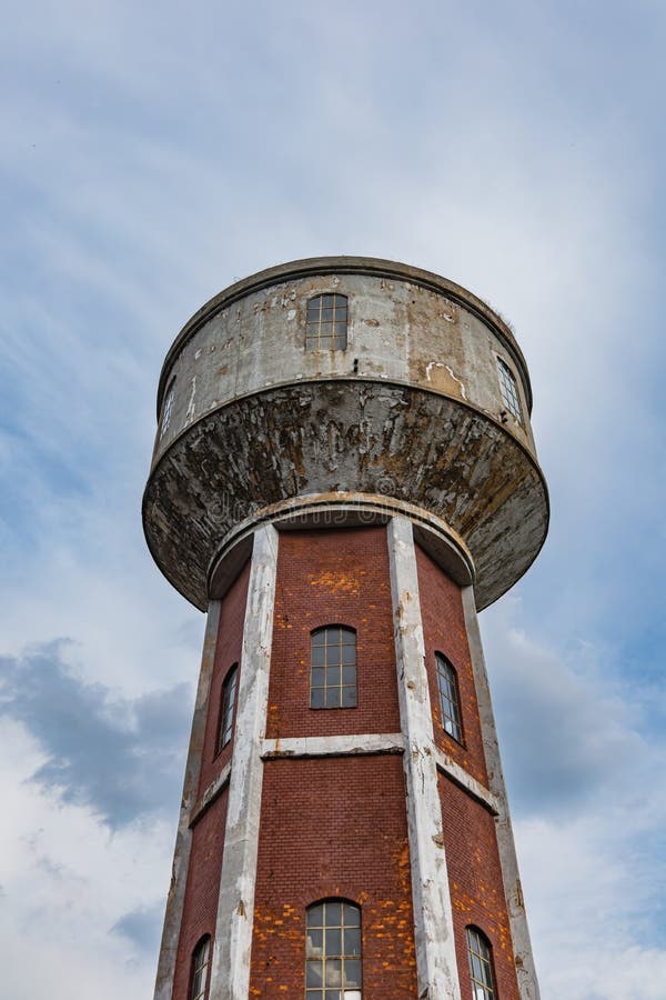High Red Brick Tower As Part of Old Factory Complex Stock Photo - Image ...