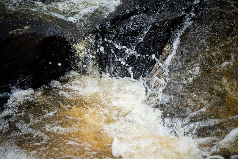 High-resolution Close-up Shot of a Stream Cascading Over a Bed of ...