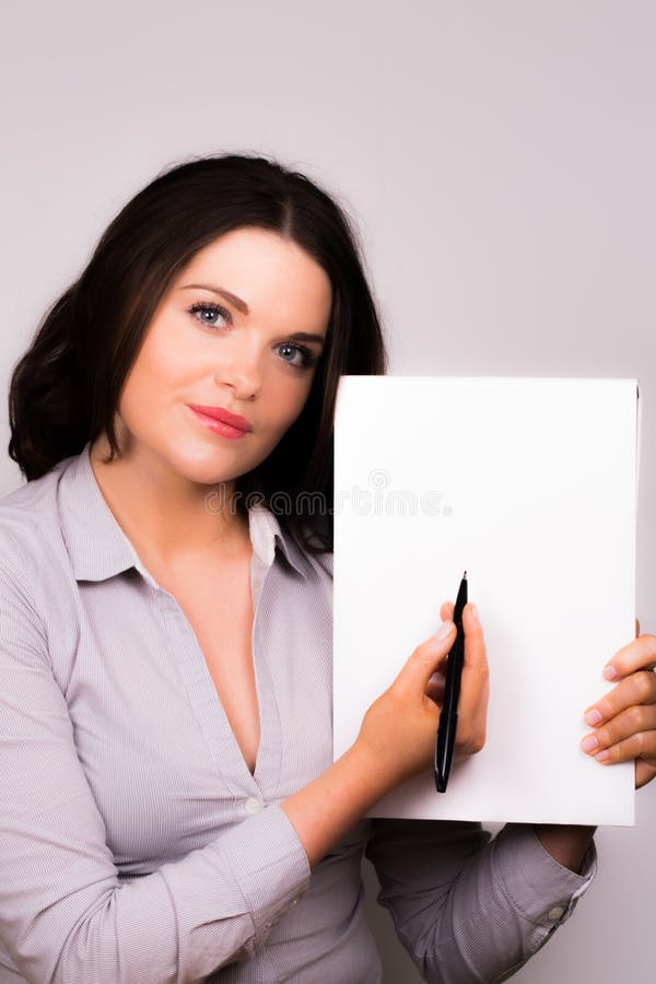 Beautiful Young Female Presenting with a Pen and Paper Stock Photo ...