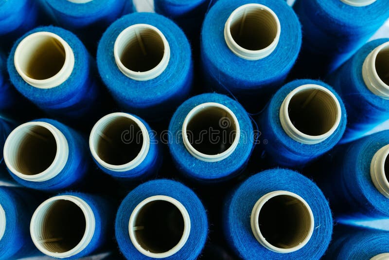 A Closeup Shot of Blue Spools of Thread Stock Photo - Image of spooling ...