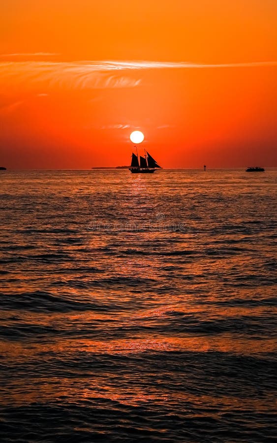 High Resolution Photo of a Boat Sailing Under a Sunset Stock Photo ...