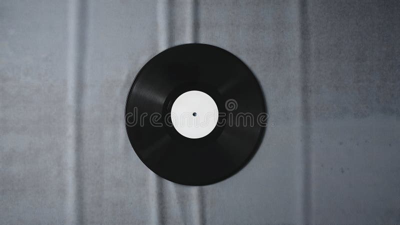 Black Vinyl Record with White Center Label on Gray Surface Stock ...