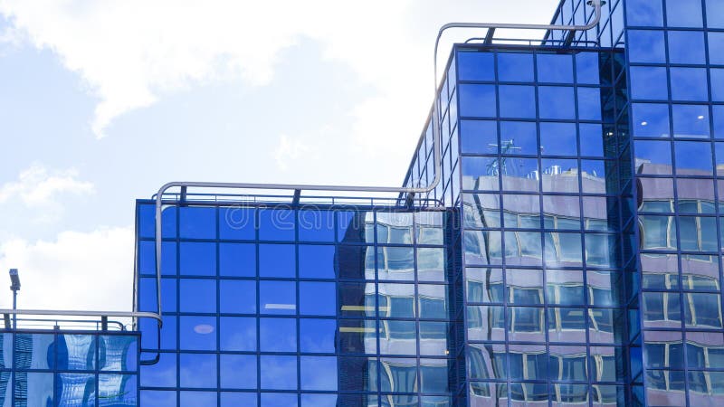 High Rise Blue Glass Office Building Reflecting Sun and City Structures ...