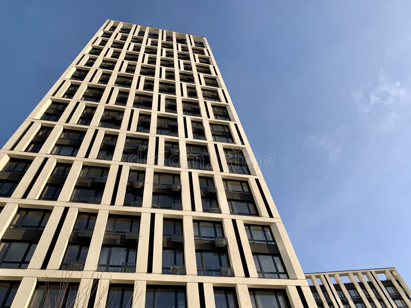 High-rise Building on a Background of Blue Sky. Tall New Building with ...