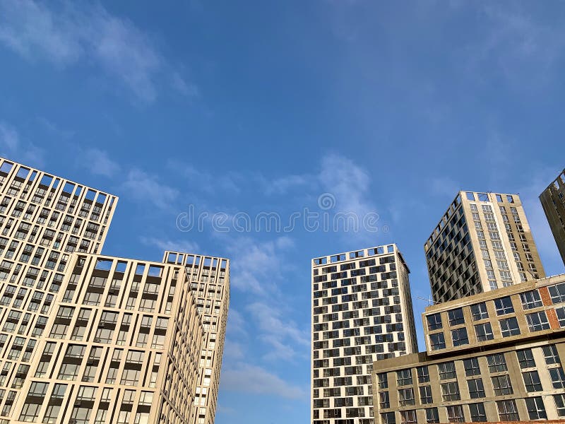 High-rise Building on a Background of Blue Sky. Tall New Building with ...