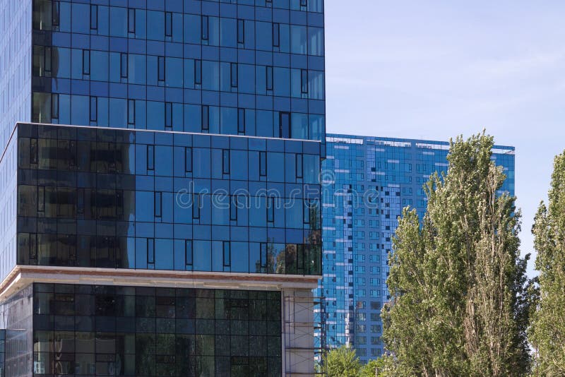 High-rise Building with a Blue Glass Facade Against the Sky and Stock ...