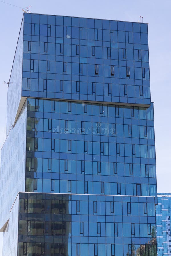 High-rise Building with a Blue Glass Facade Against the Sky Stock Photo ...