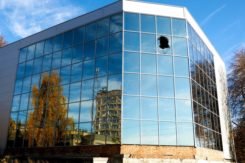 A High-rise Building with a Blue Window Smashed by Vandals Stock Photo ...