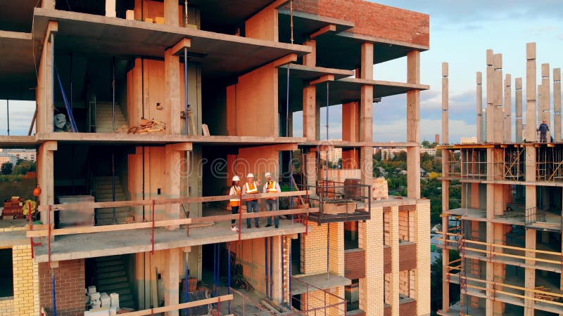 High-rise Building in Progress with Engineers Standing in it Stock ...
