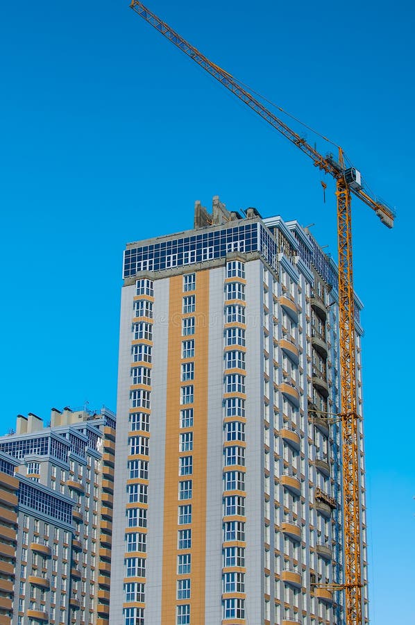 High-rise Building, and Standing Next To the Tower Crane Stock Photo ...