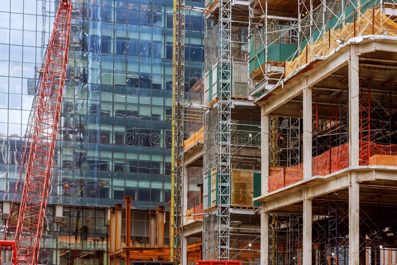 High-rise Crane Supplies Material To a High-rise Building Construction ...