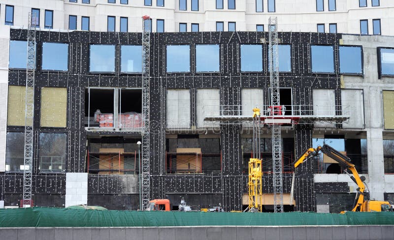 High-rise Building Under Construction with a Waterproofing and Warming ...