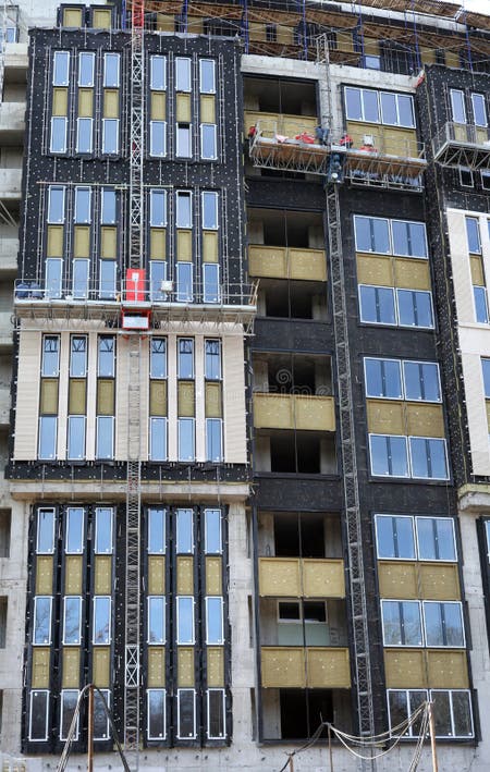 High-rise Building Under Construction with a Waterproofing and Warming ...