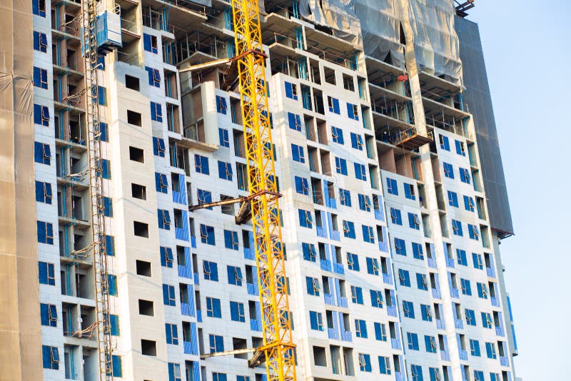 High Rise Construction Building Site with Crane Against Blue Sky Stock ...