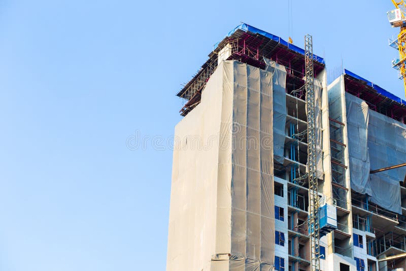 High Rise Construction Building Site with Crane Against Blue Sky Stock ...