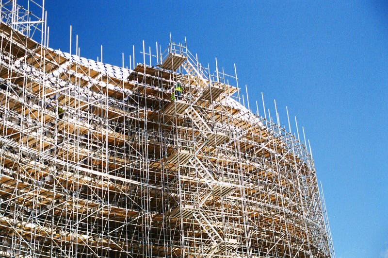 High Rise Construction Scaffolding Under a Blue Sky Stock Image - Image ...