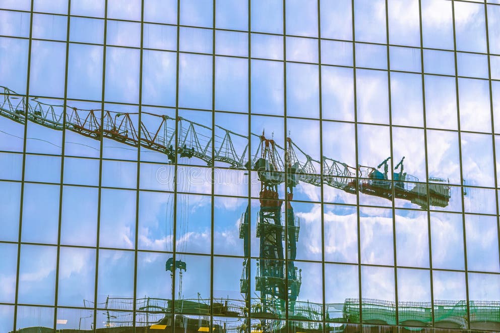 High Rise Construction Scene Reflected on Building Windows. Stock Image ...
