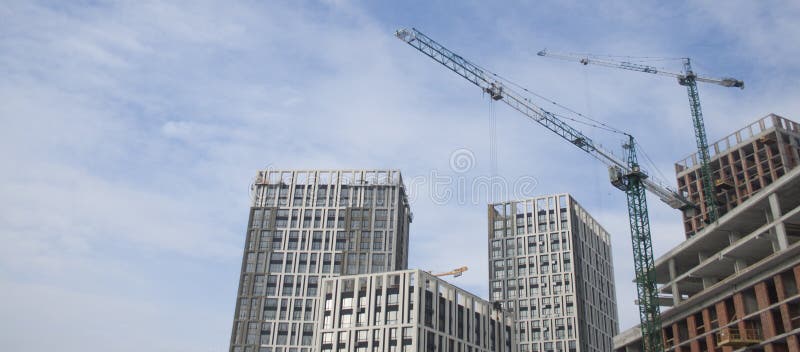 High-rise Multi-storey Buildings Under Construction. Tower Cranes Near ...