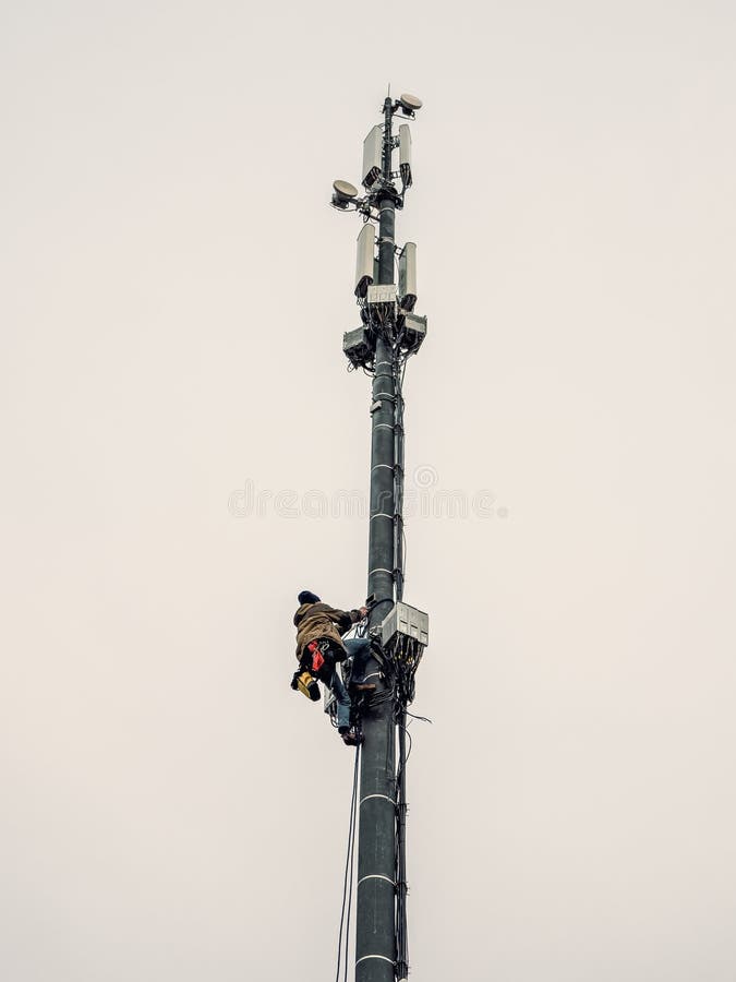 A High-rise Worker Works on a Cell Tower Stock Image - Image of mast ...