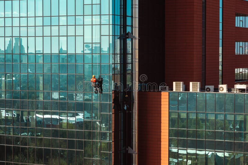 High-rise Workers Cleaning the Windows of a Skyscraper Editorial Photo ...