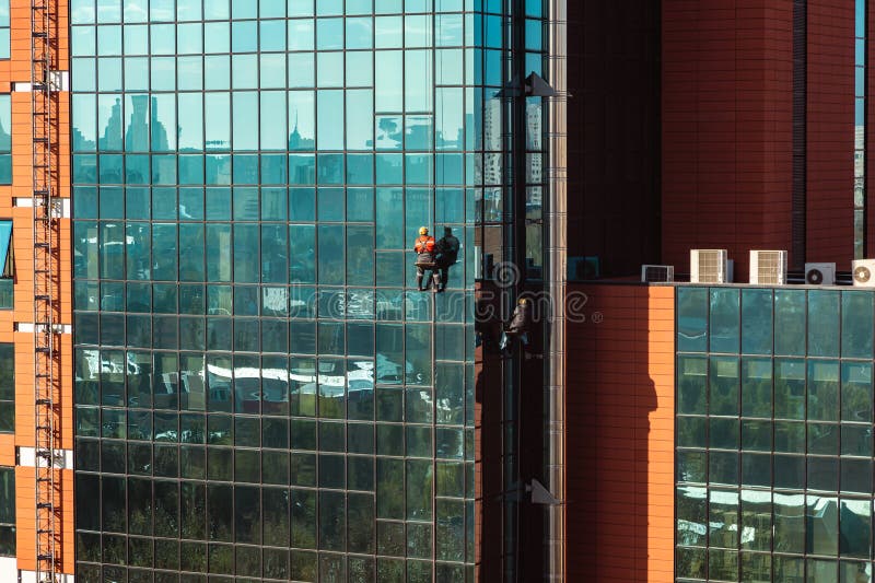 High-rise Workers Cleaning the Windows of a Skyscraper Editorial Photo ...