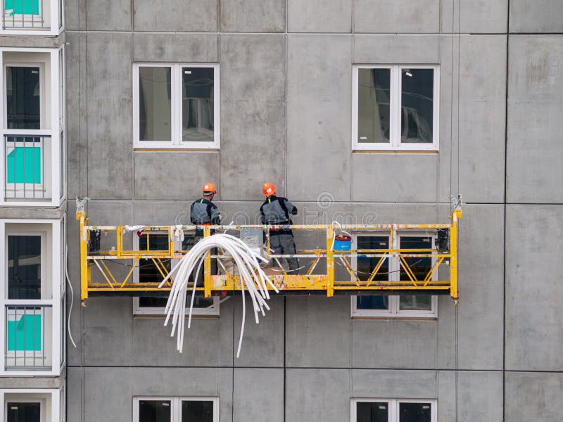 High-rise Workers Work on the Lift in the Construction of High-rise ...