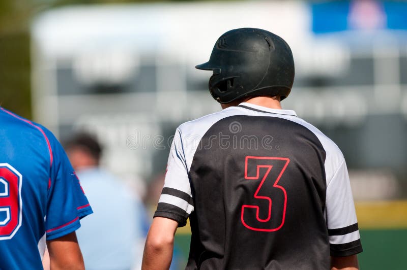 High School Baseball Player with Long Hair Leaning on Dugout Fen Stock ...