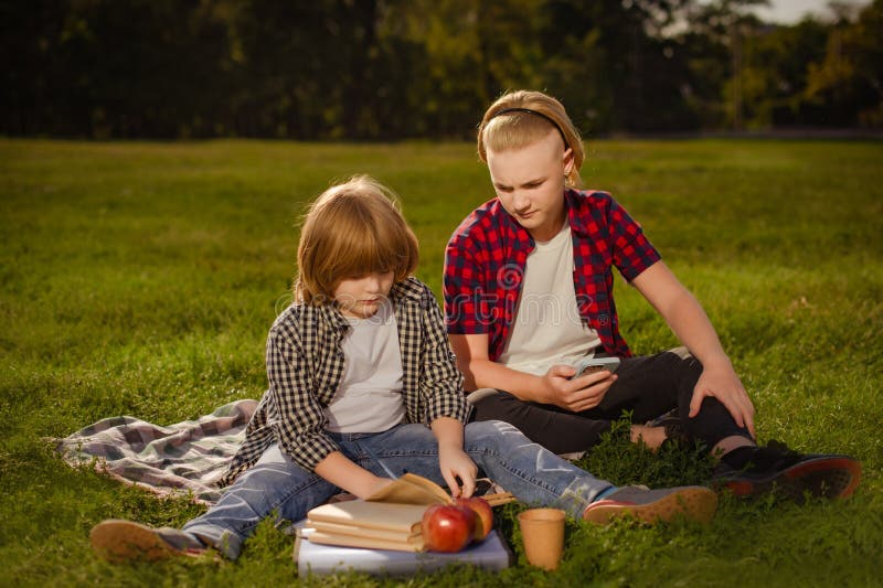 High School Boy Student Checking Junior School Student S Homework on ...