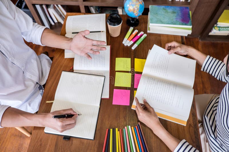 High School or College Student Group Sitting at Desk in Library ...