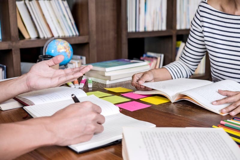 High School or College Student Group Sitting at Desk in Library ...