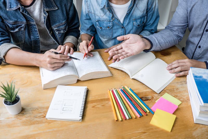 High School or College Student Group Sitting at Desk in Library ...