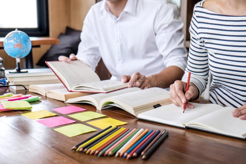High School or College Student Group Sitting at Desk in Library ...