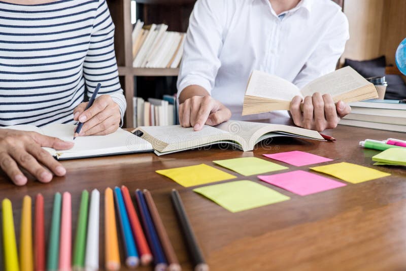 High School or College Student Group Sitting at Desk in Library ...
