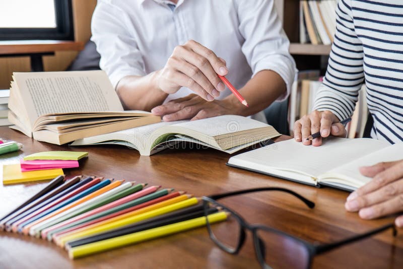 High School or College Student Group Sitting at Desk in Library ...