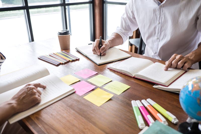 High School or College Student Group Sitting at Desk in Library ...