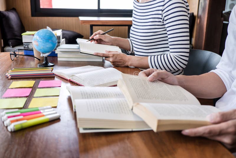High School or College Student Group Sitting at Desk in Library ...