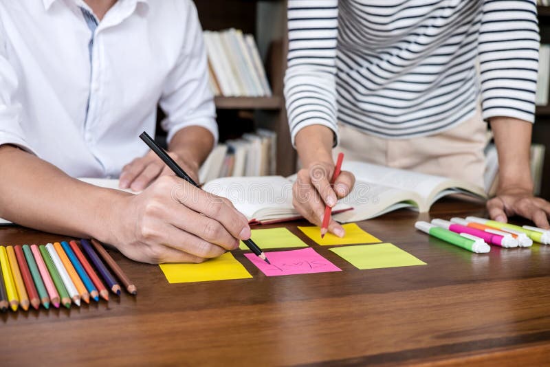 High School or College Student Group Sitting at Desk in Library ...