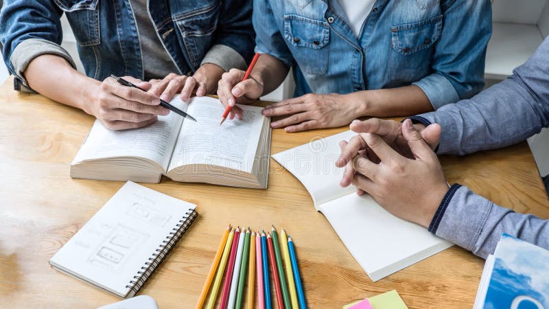 High School or College Student Group Sitting at Desk in Library ...