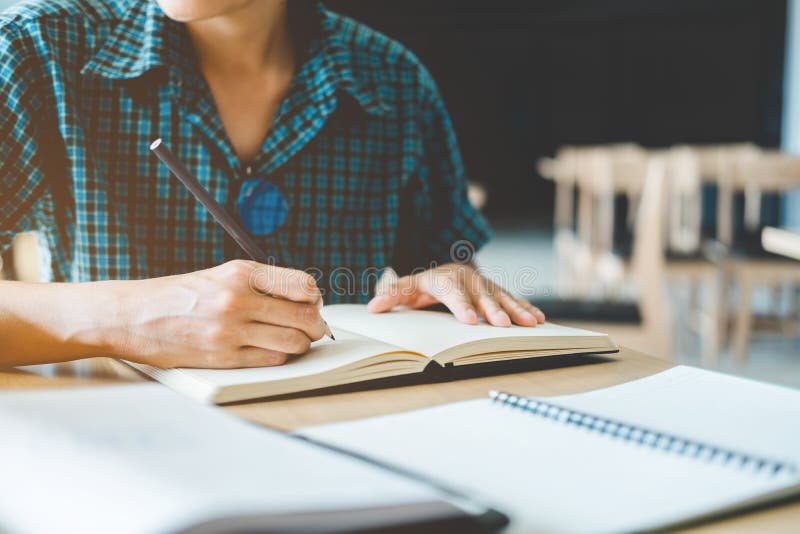 High School or College Student Studying and Reading in Library Stock ...