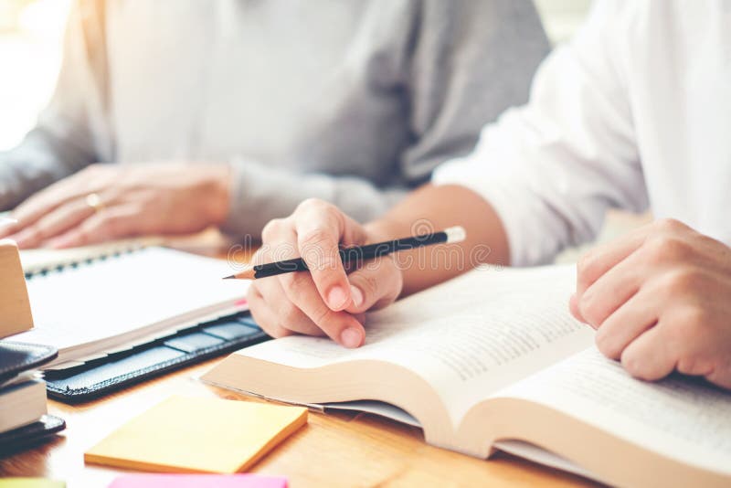 High School or College Students Studying and Reading Together in Stock ...