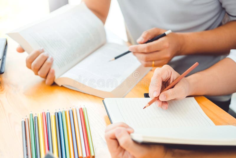 High School or College Students Studying and Reading Together in ...