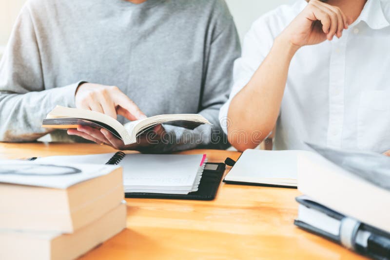 High School or College Students Studying and Reading Together in ...