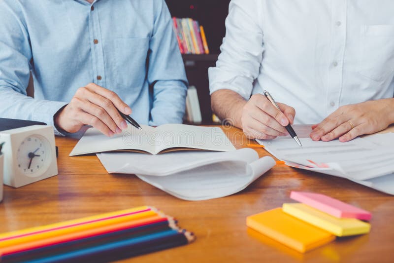 High School or College Students Studying and Reading Together in ...